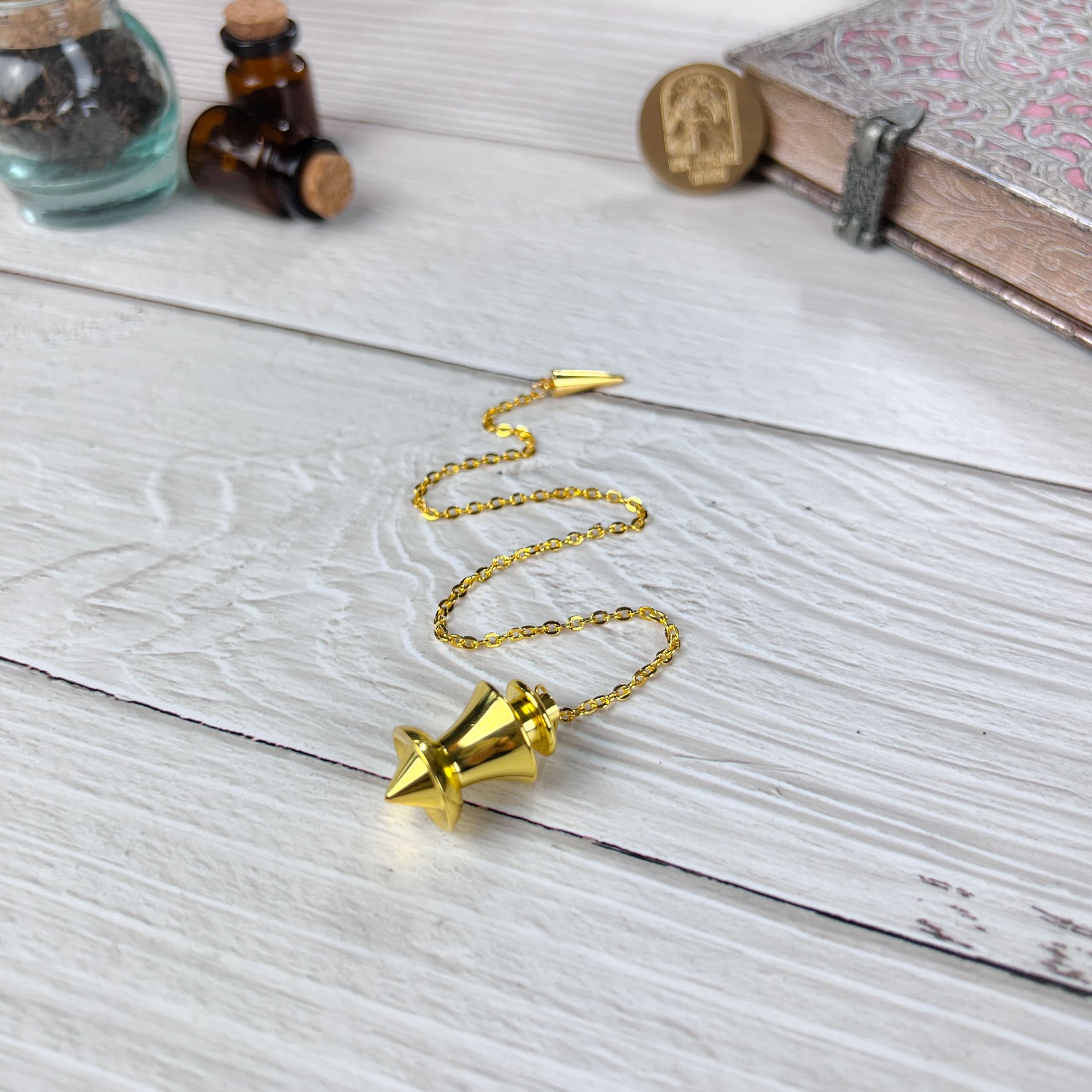 Golden point and dome dowsing metal pendulum with a spike charm ...